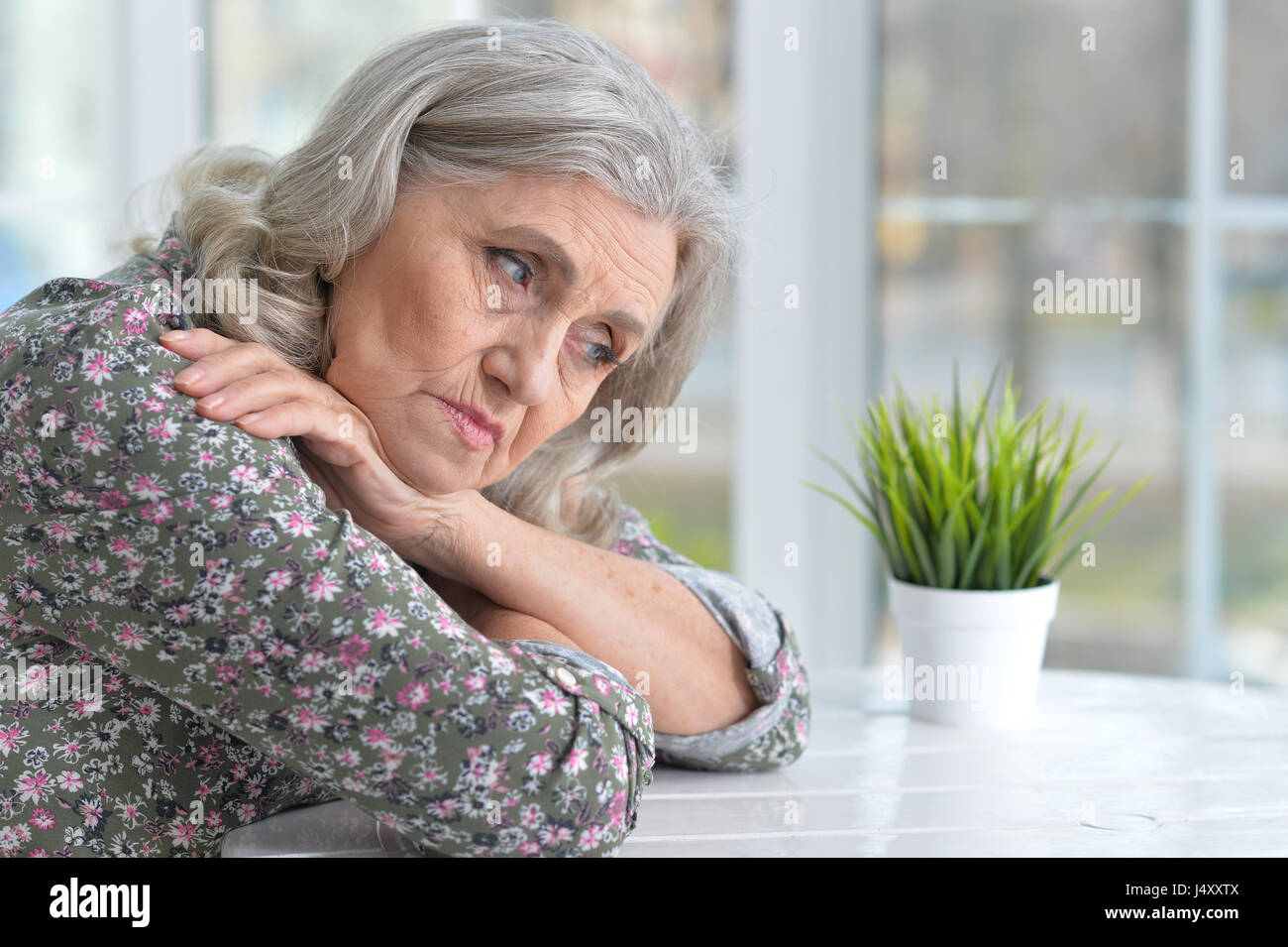 Beautiful sad elderly woman Stock Photo - Alamy
