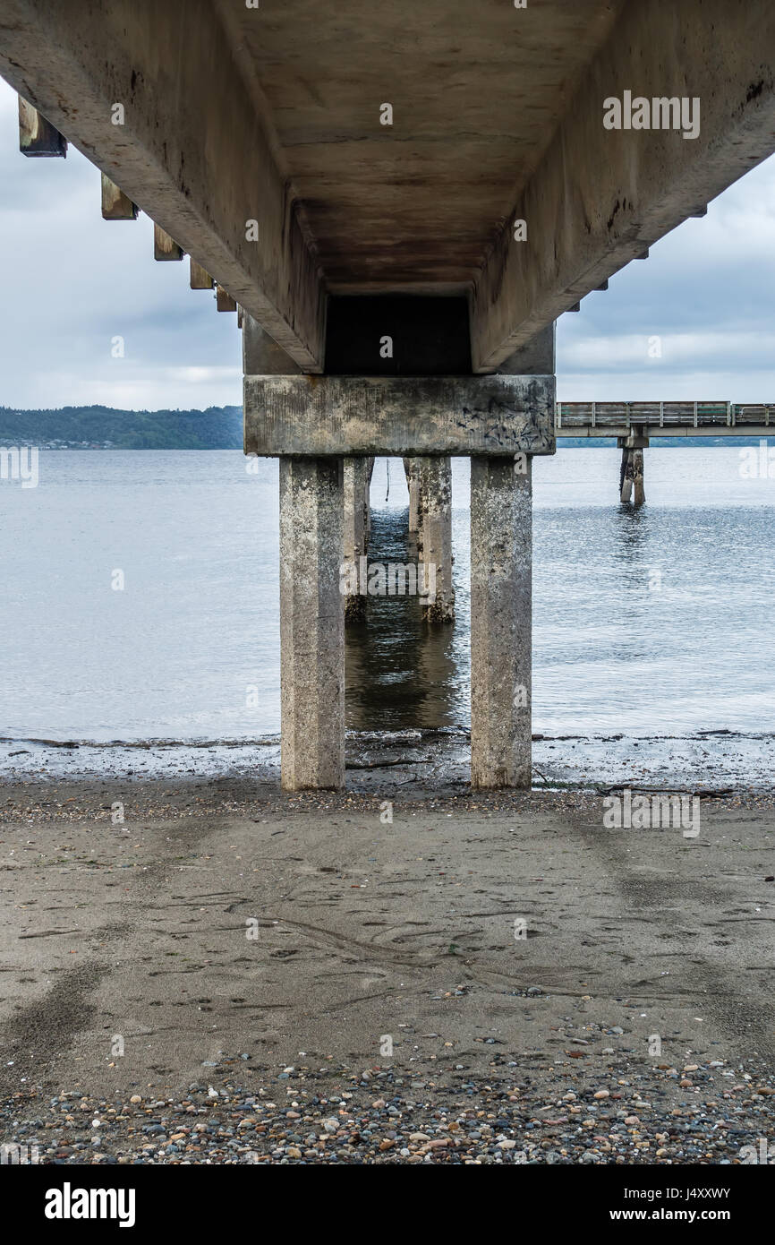 A view from beneath the pier at Dash Point, Washington. The tide is low ...