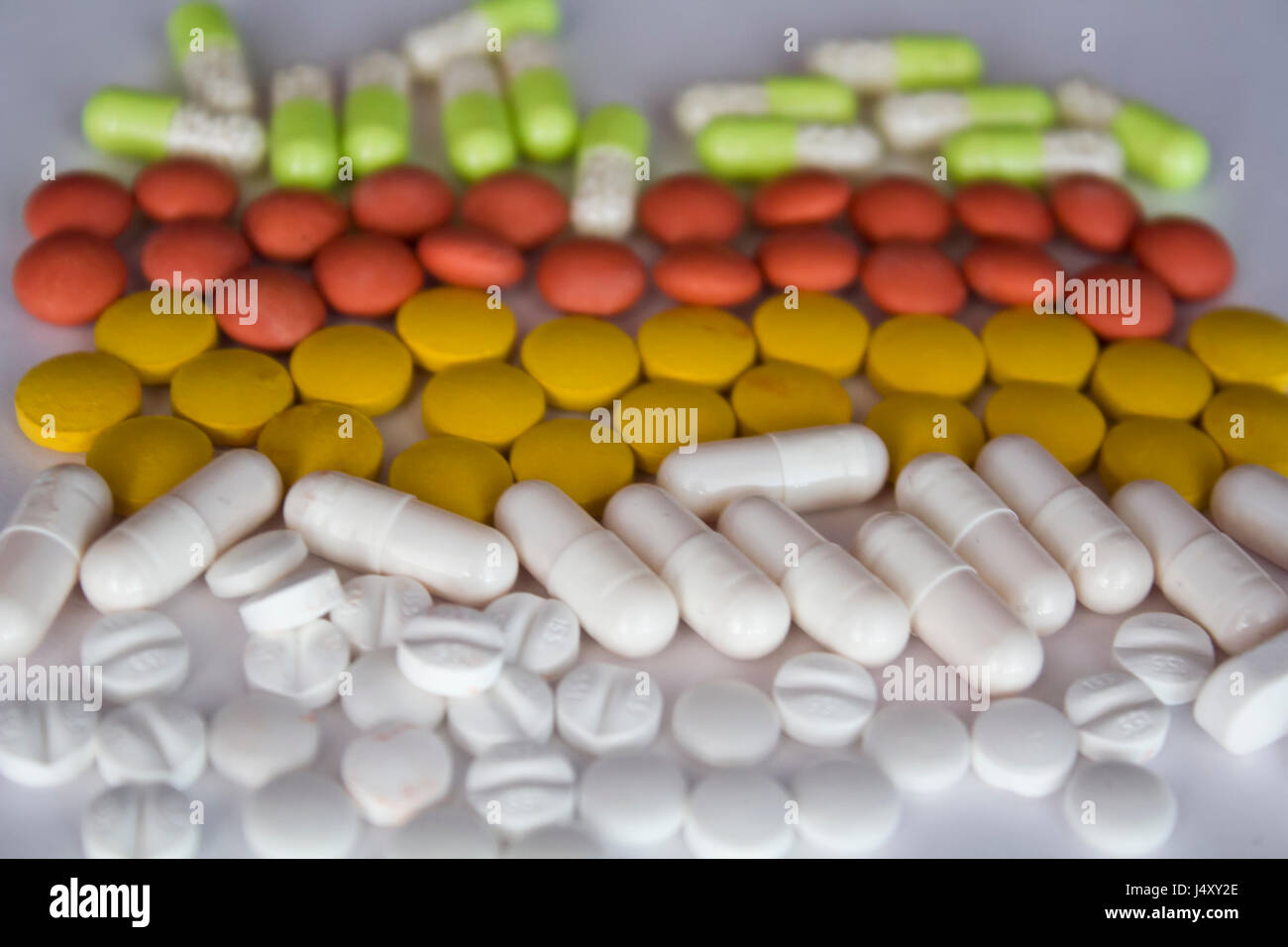Assortment of pills divided by color Stock Photo - Alamy