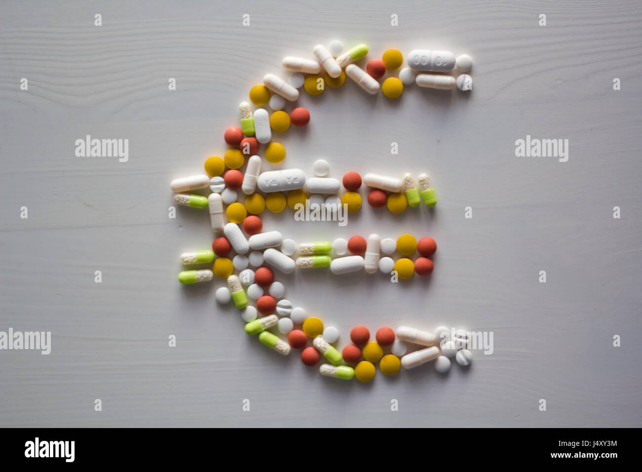 Pills in shape of Euro money sign symbol Stock Photo - Alamy