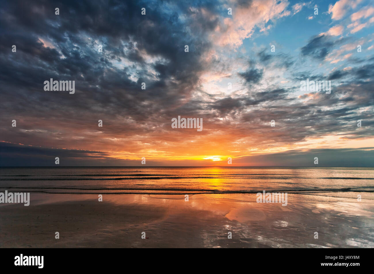 Tropical beach in ebb time on sunset background Stock Photo - Alamy
