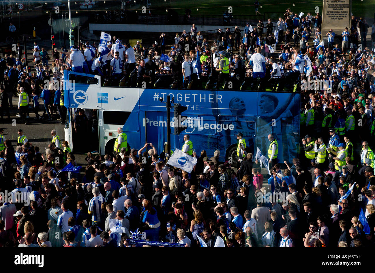 Brighton and Hove Albion football fans cheer their team during the bus ...