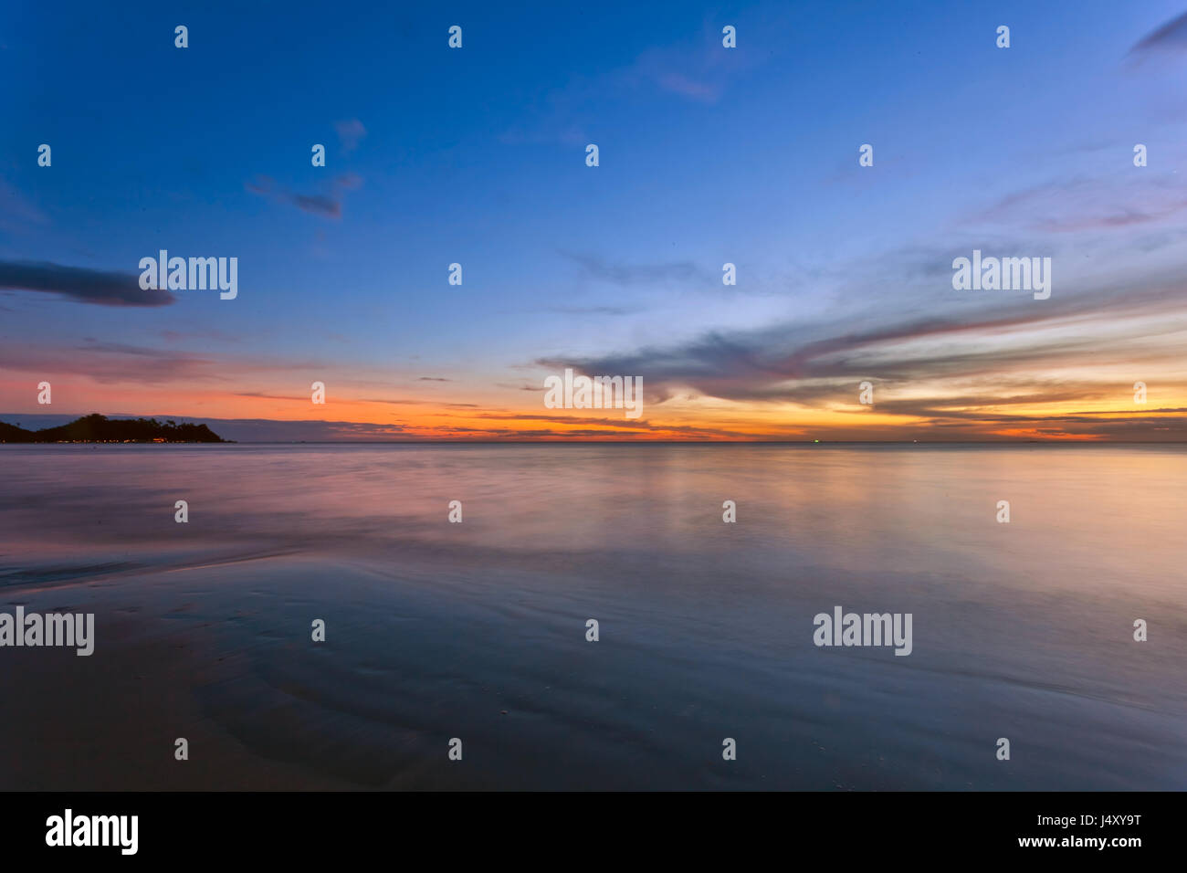 Tropical beach in ebb time on sunset background Stock Photo - Alamy