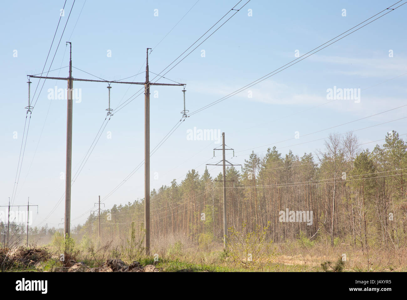 High voltage pylon close to motorway. Power transmission line Stock ...