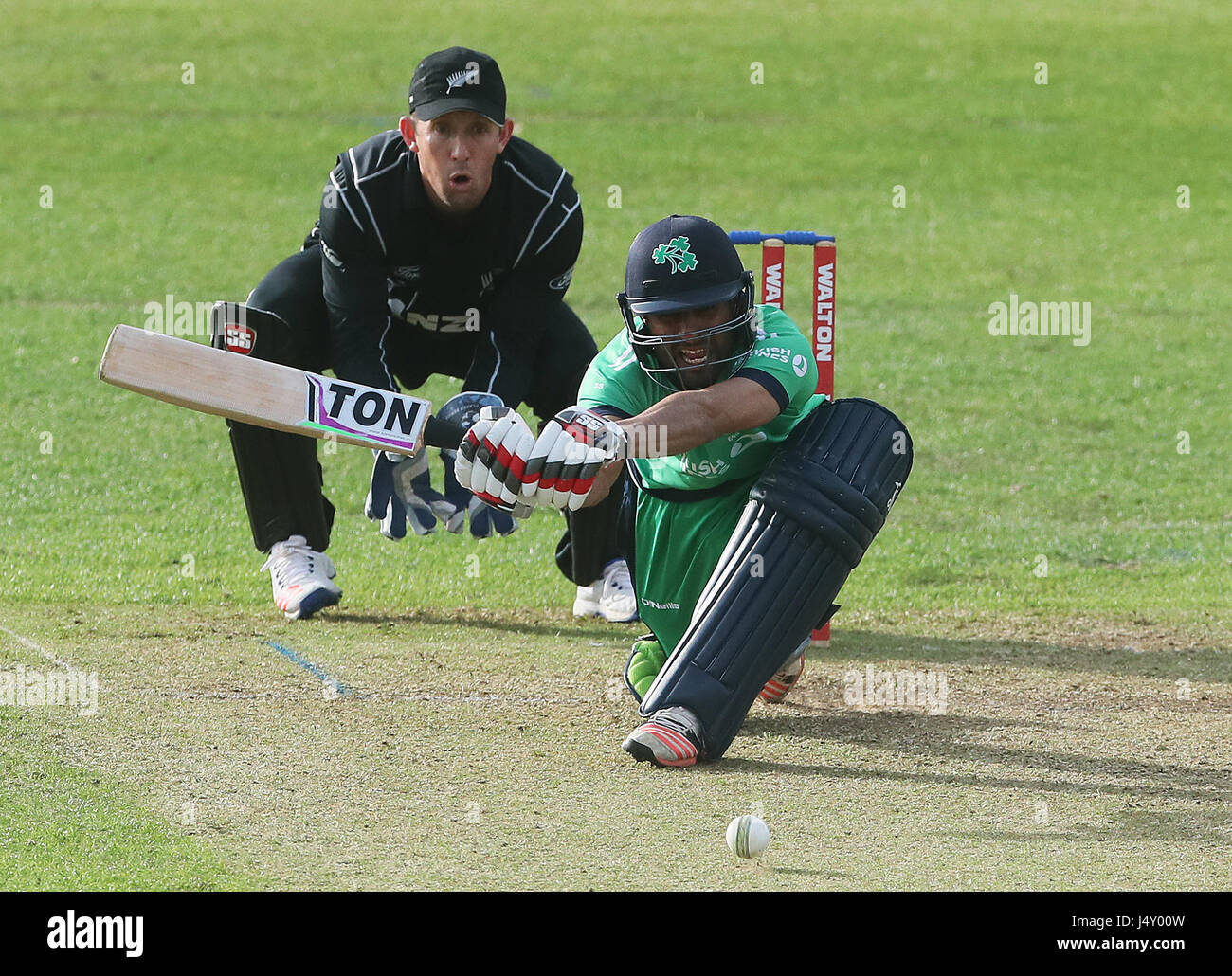Ireland's Simi Singh bats as New Zealand's Luk Ronchi looks on during ...