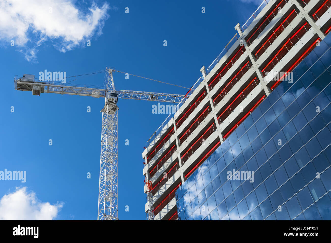 Tower crane and modern building under construction. Industrial ...