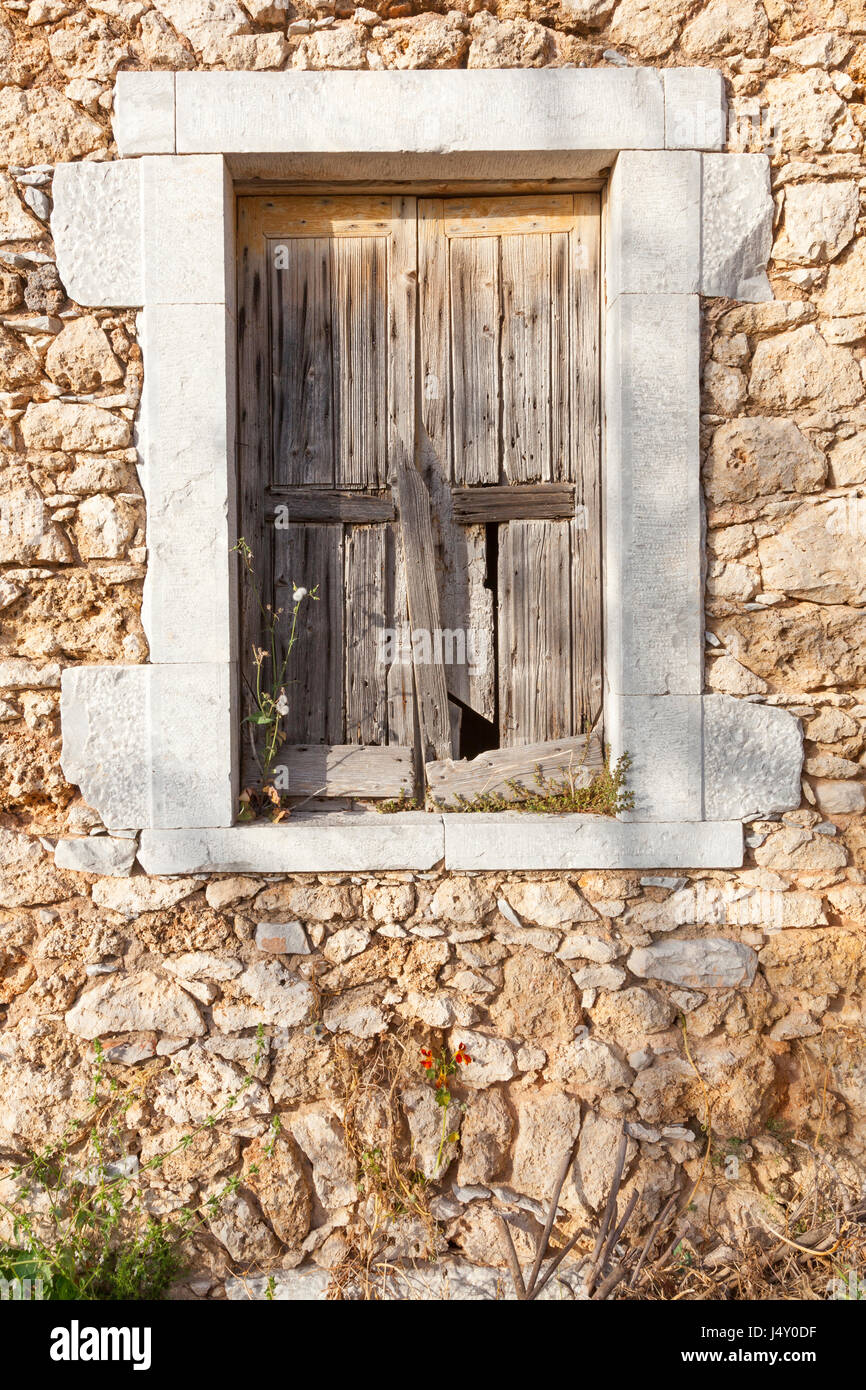 very old shutters in front of window in ancient greek stone building ...