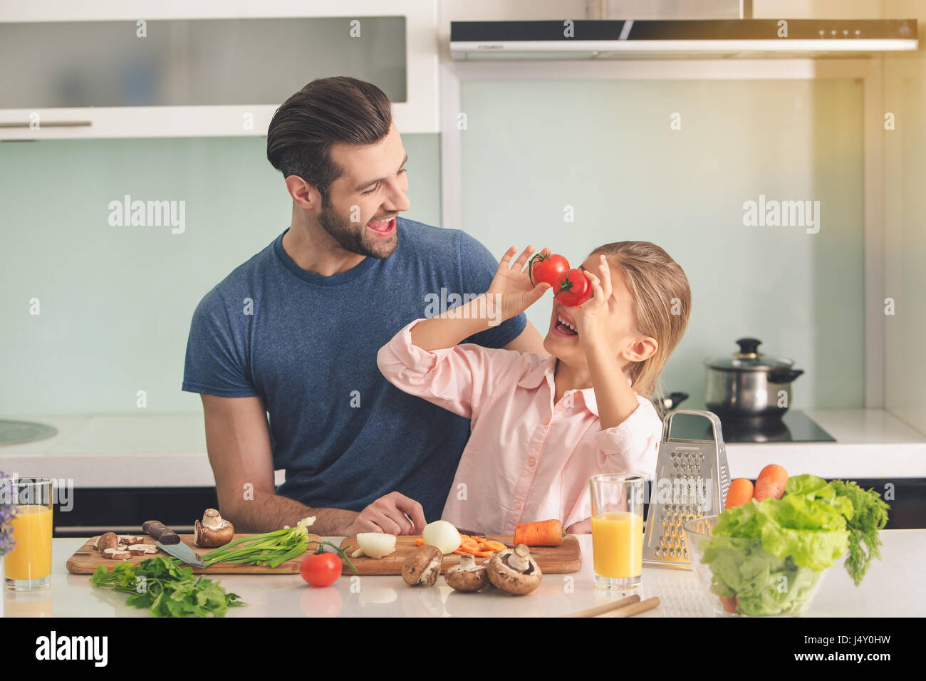 Young father and daughter cooking meal together Stock Photo - Alamy