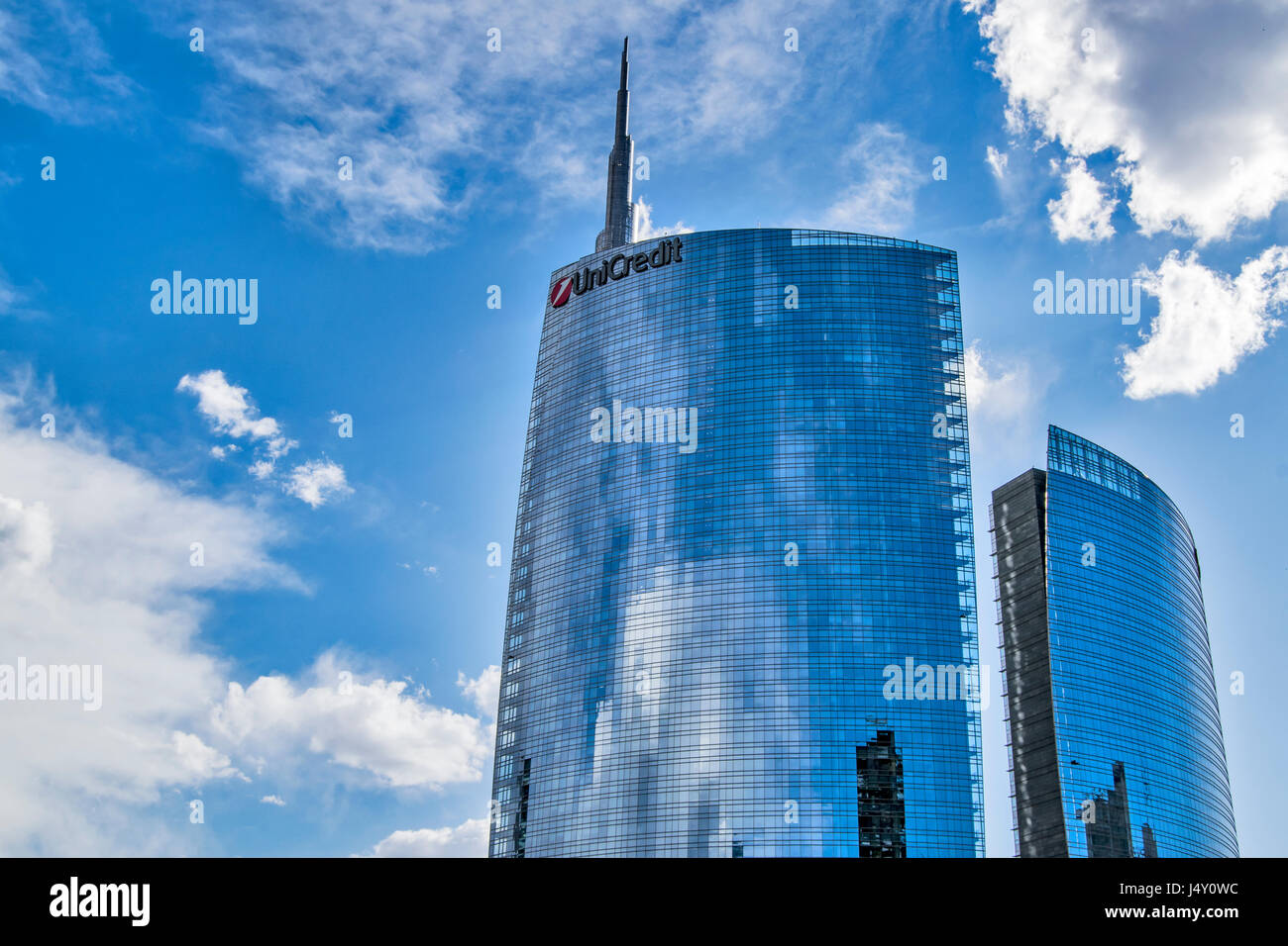 a view of Unicredit tower in Milan downtown, with a blue sky with ...