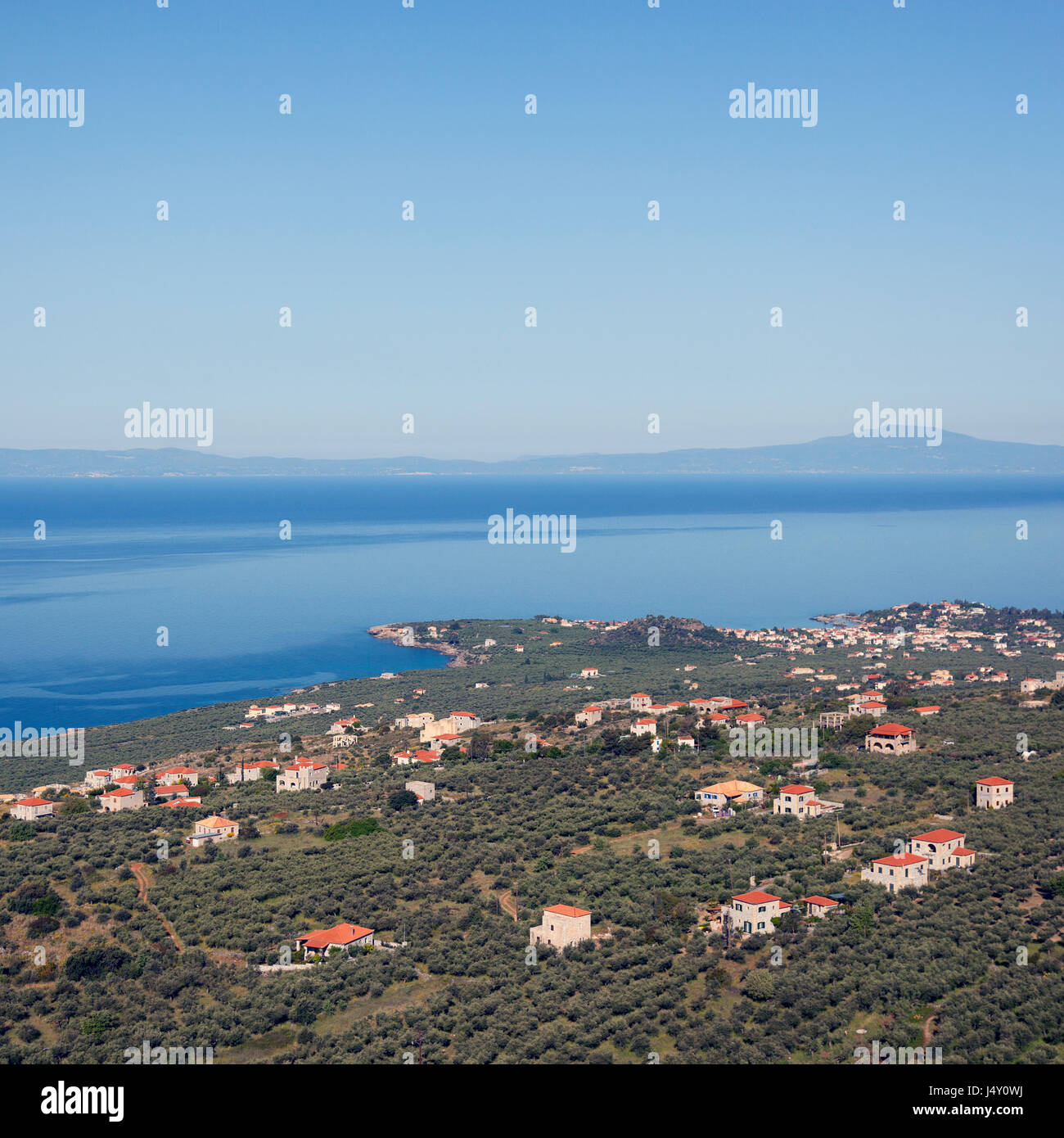 village of stoupa and blue sea seen from the mountains behind it on ...