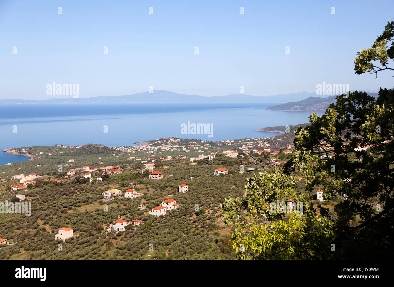 village of stoupa and blue sea seen from the mountains behind it on ...
