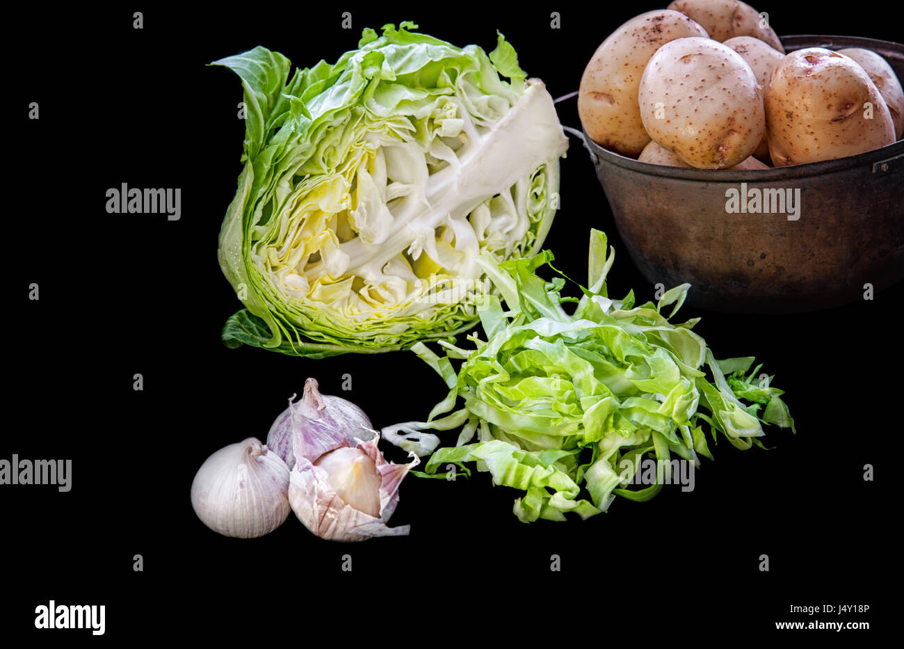 green cabbage half head half cut into strips for a salad with the ...
