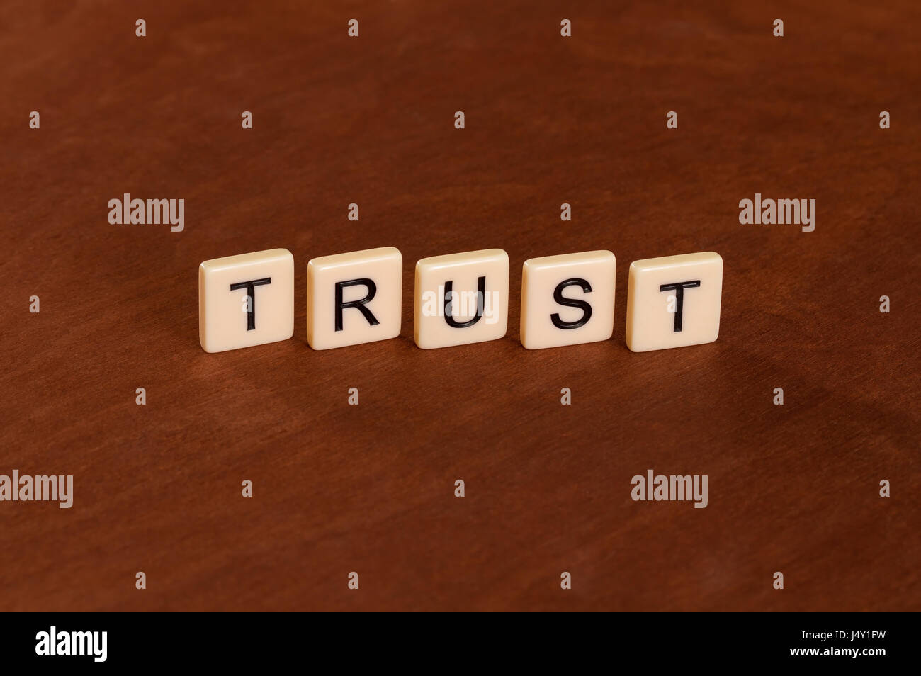 Trust sign. Loyalty concept. Ivory tiles with capital letters on ...