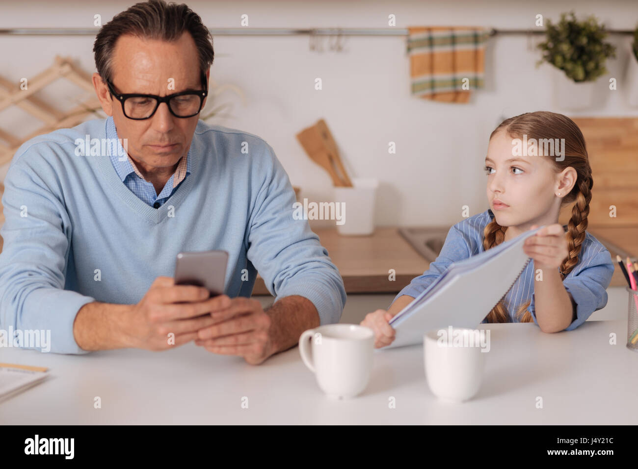 Indifferent businessman ignoring little kid at home Stock Photo - Alamy