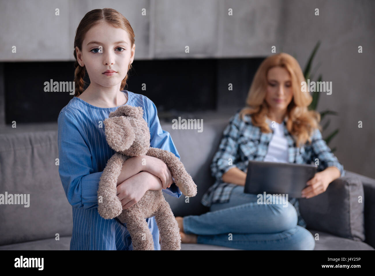 Sad little child waiting for busy parent attention at home Stock Photo ...
