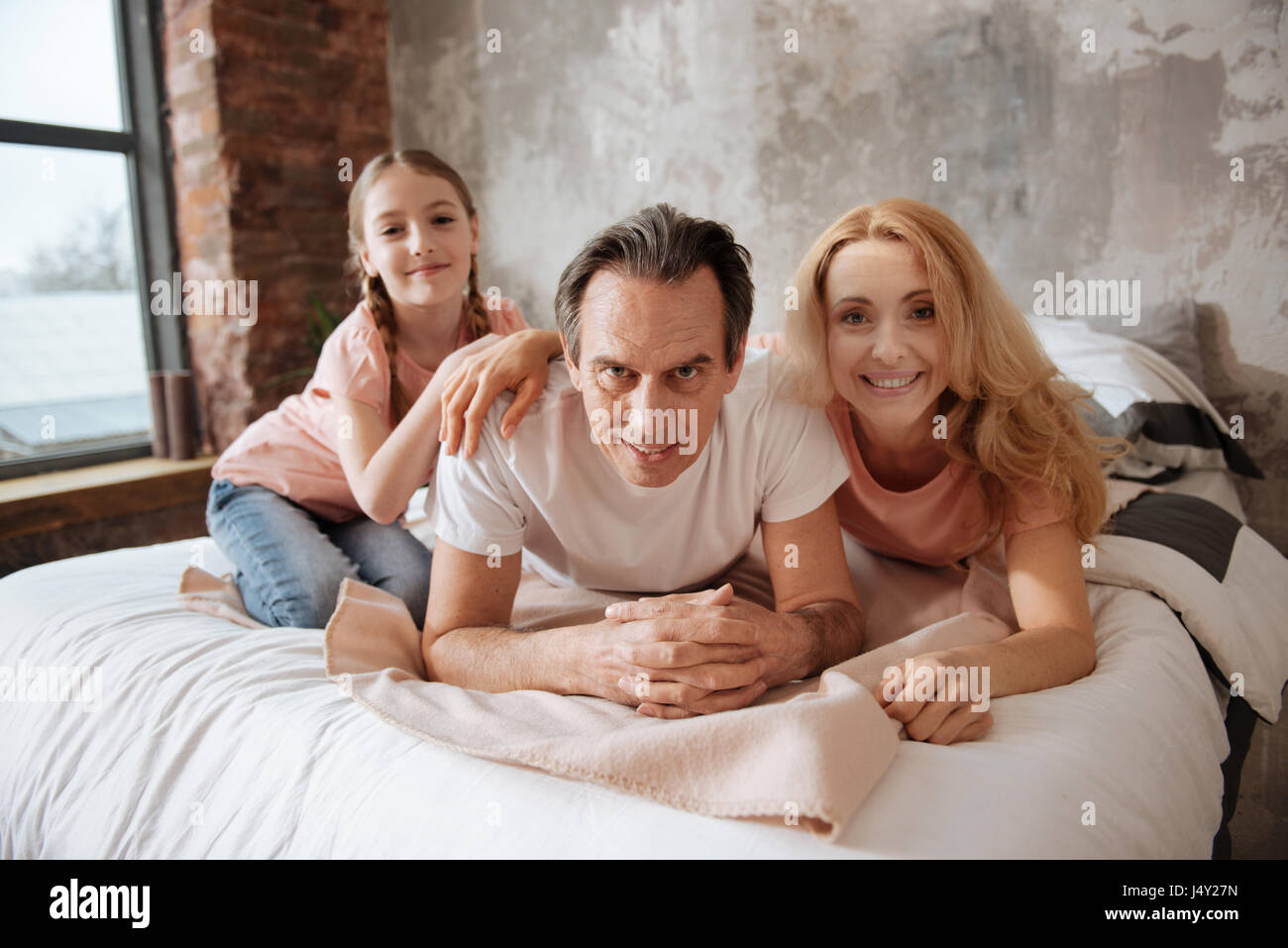 Relaxed family enjoying weekend at home Stock Photo - Alamy