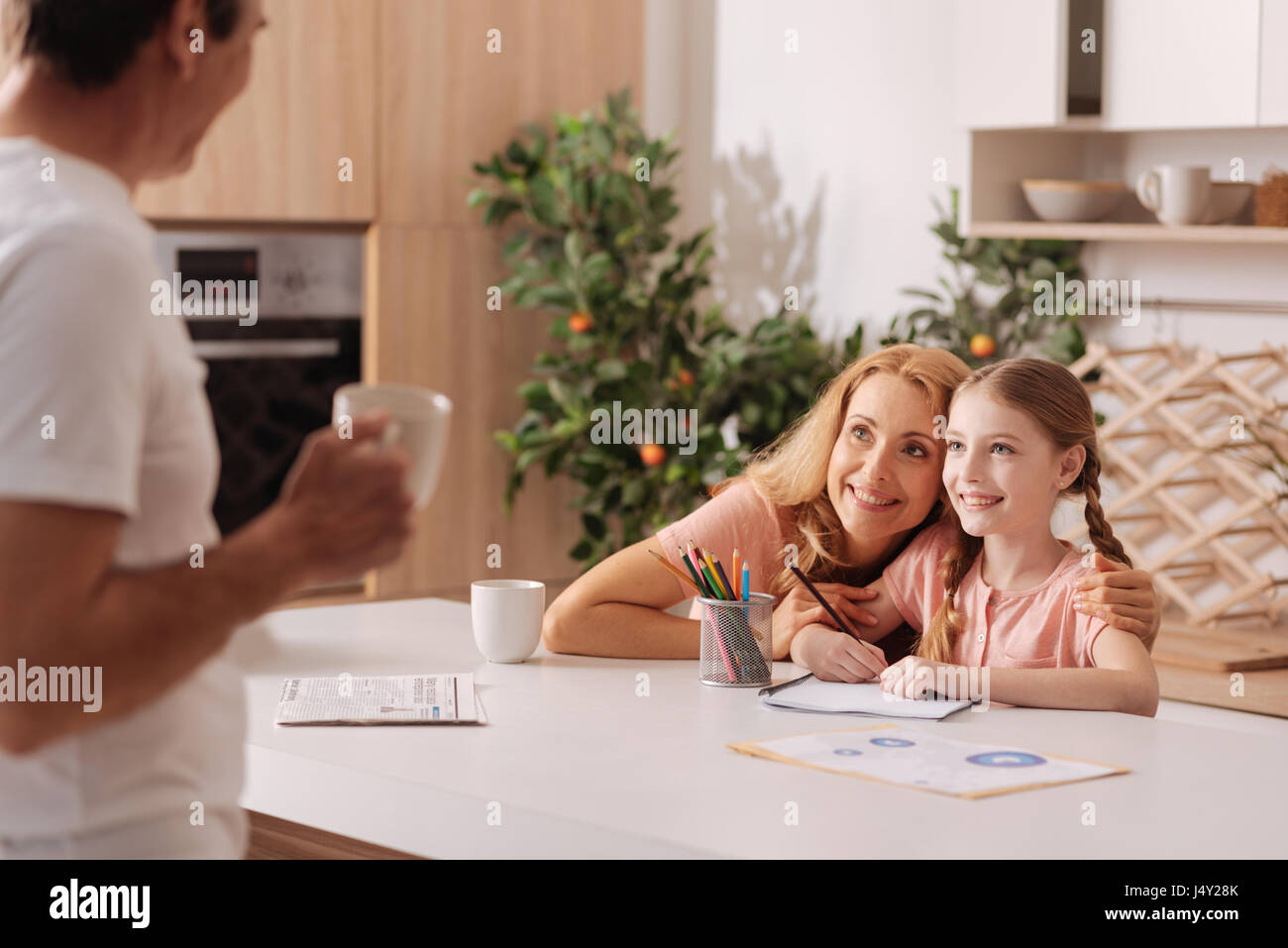 Cheerful family spending weekend at home Stock Photo - Alamy