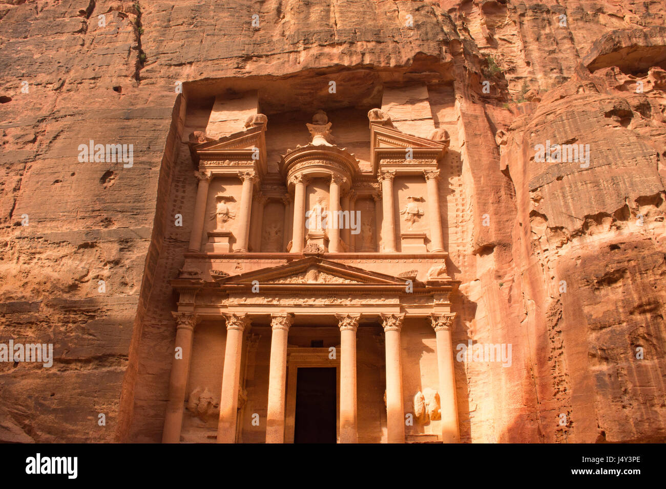 The Treasury, an ancient building in Petra, Jordan. The orange stone ...
