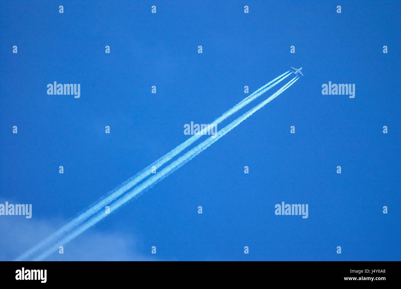 Jet contrails in a blue sky Stock Photo - Alamy