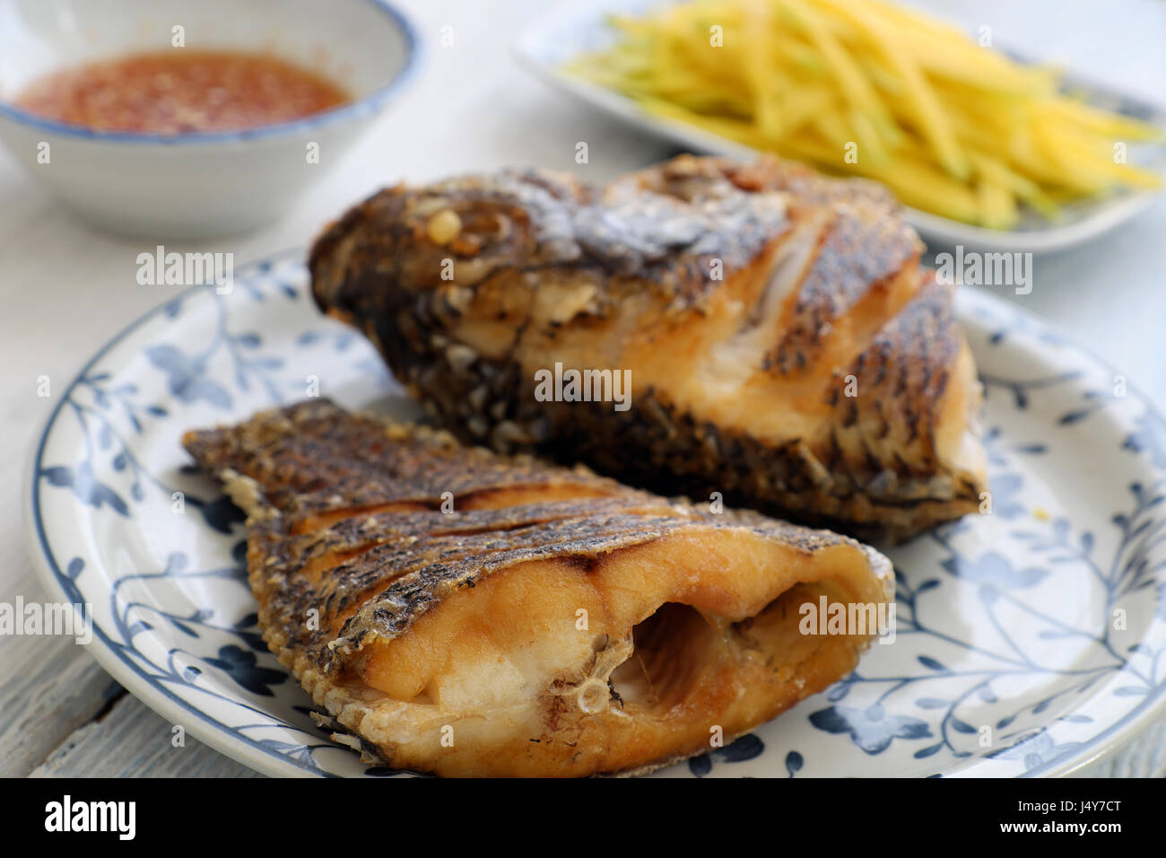 Vietnamese food for daily meal, fried fish with mango and fish sauce ...
