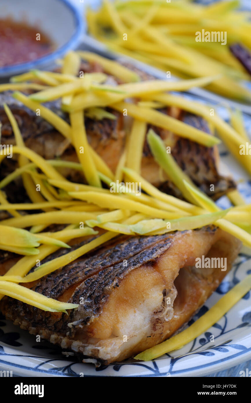 Vietnamese food for daily meal, fried fish with mango and fish sauce ...