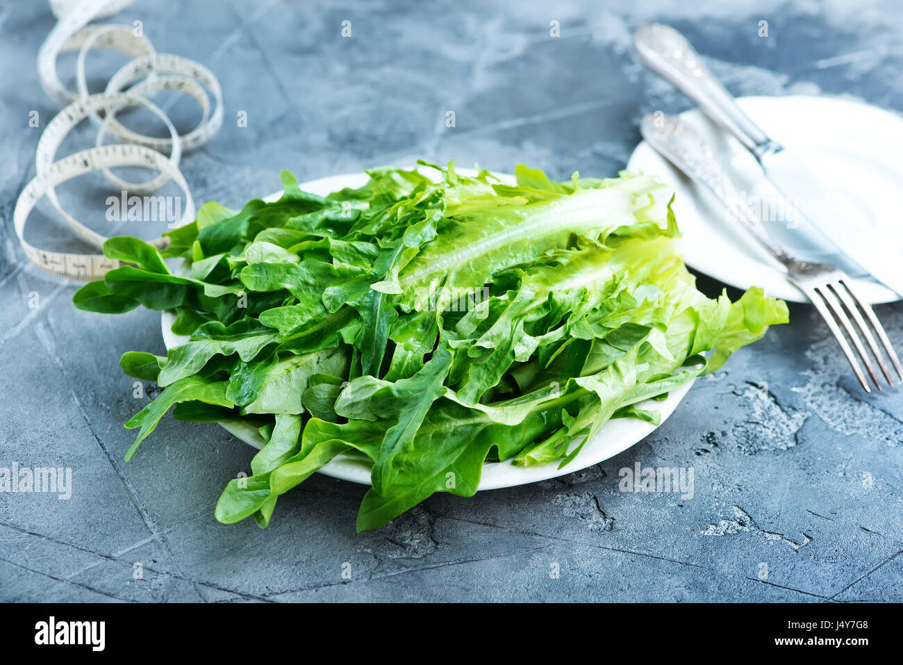 fresh rucola on plate and on a table Stock Photo - Alamy