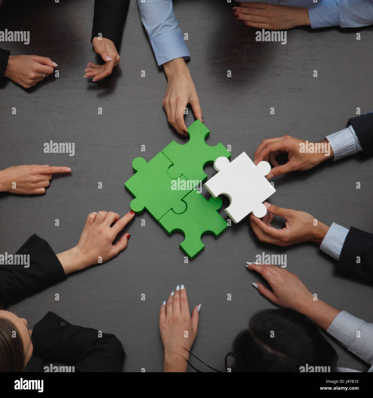 Group of business people assembling jigsaw puzzle, team support and ...