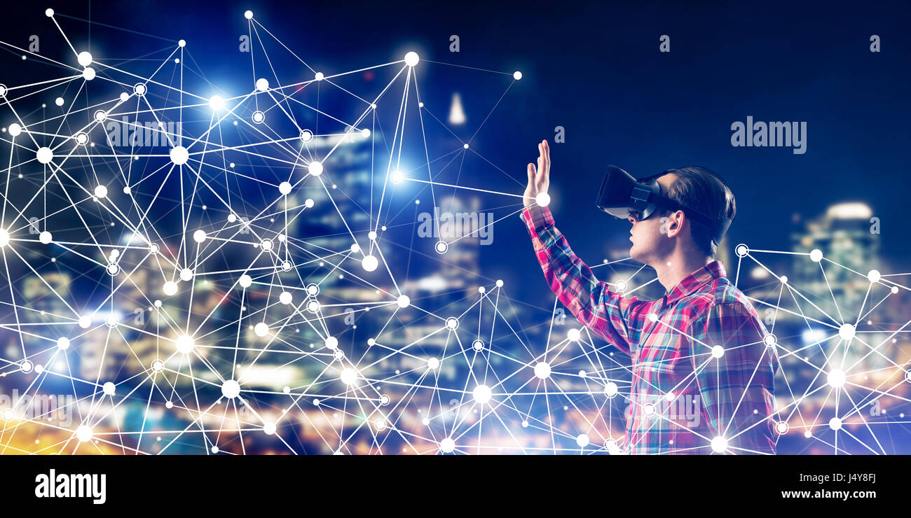 Guy wearing checked shirt and virtual mask reaching hand to feel Stock ...