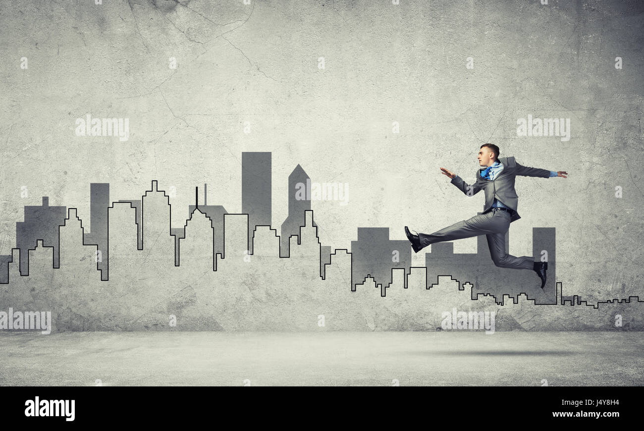 Businessman jumping high Stock Photo - Alamy