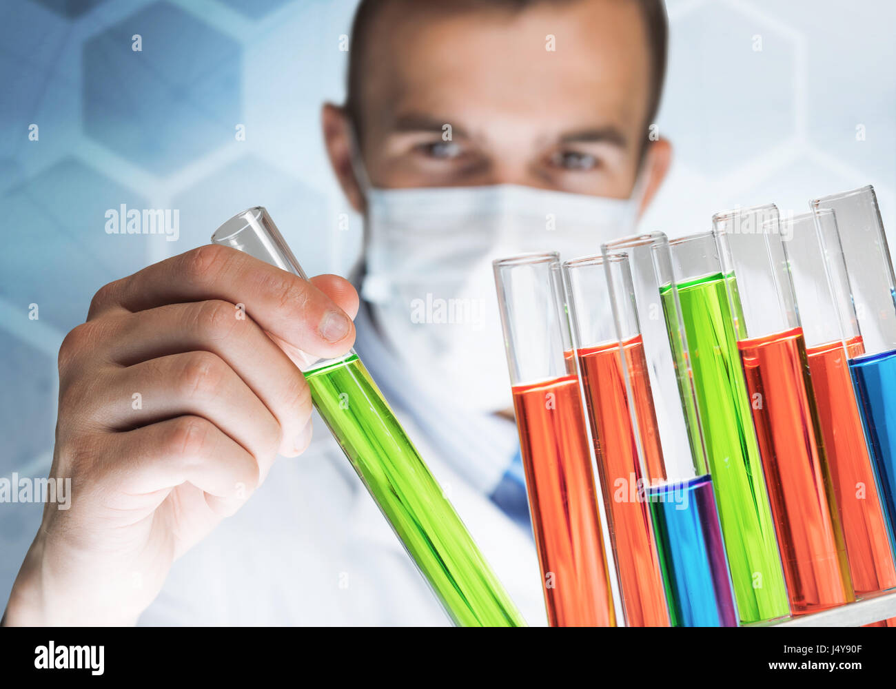 Portrait of concentrated male scientist working with reagents in ...