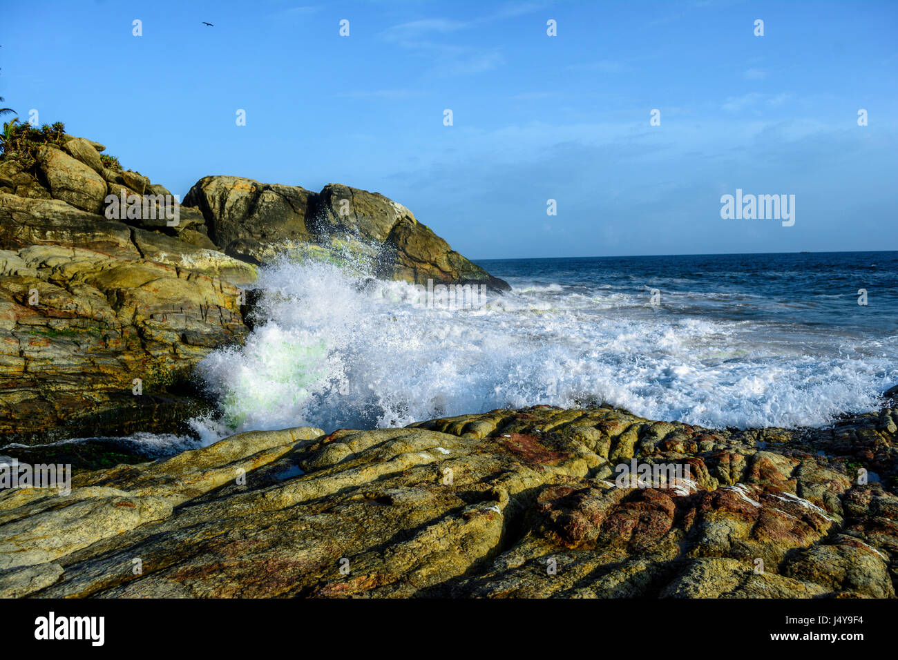waves washing over Rocks Kerala Indian ocean Stock Photo - Alamy