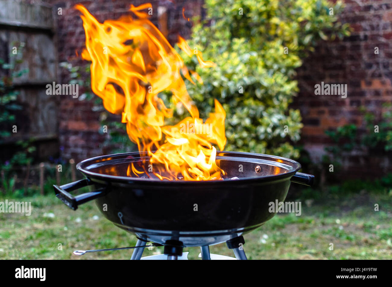 Flame on barbeque grill in a garden Stock Photo - Alamy