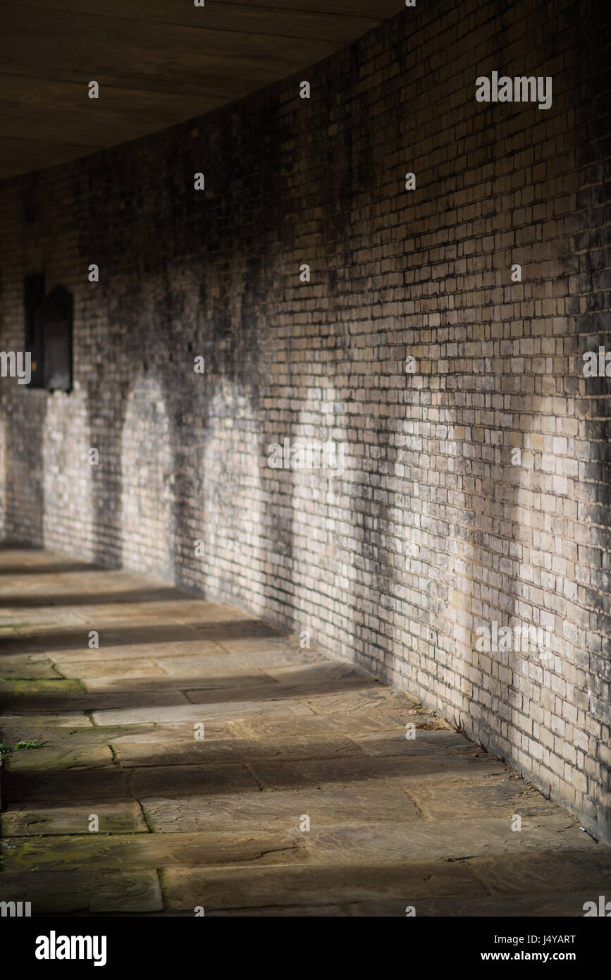 Arches on brick in shadows Stock Photo - Alamy
