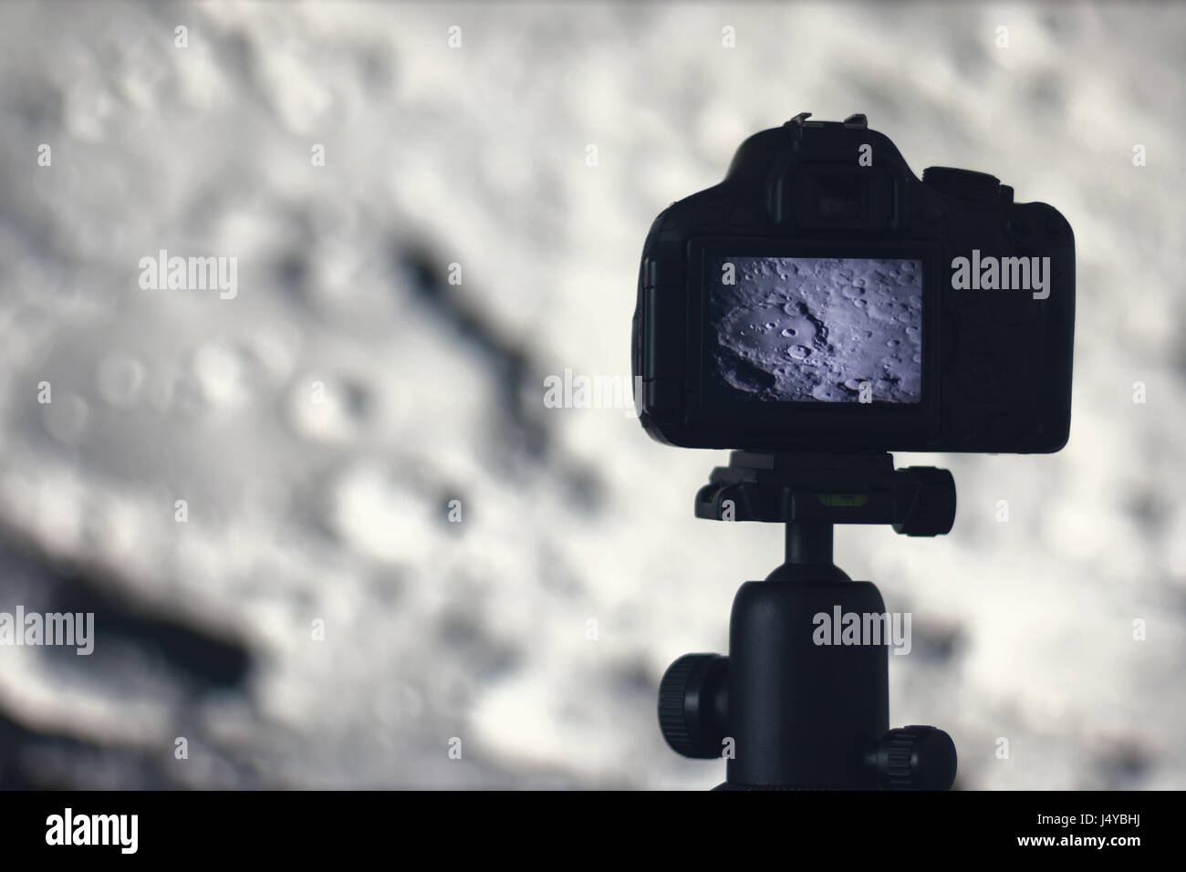 Moon photography. Camera with tripod capturing moon. Moon crater ...