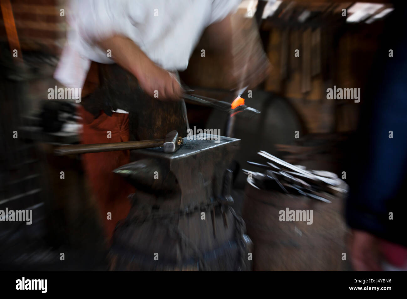 18th century blacksmith reenactor working in blacksmith shop - USA ...