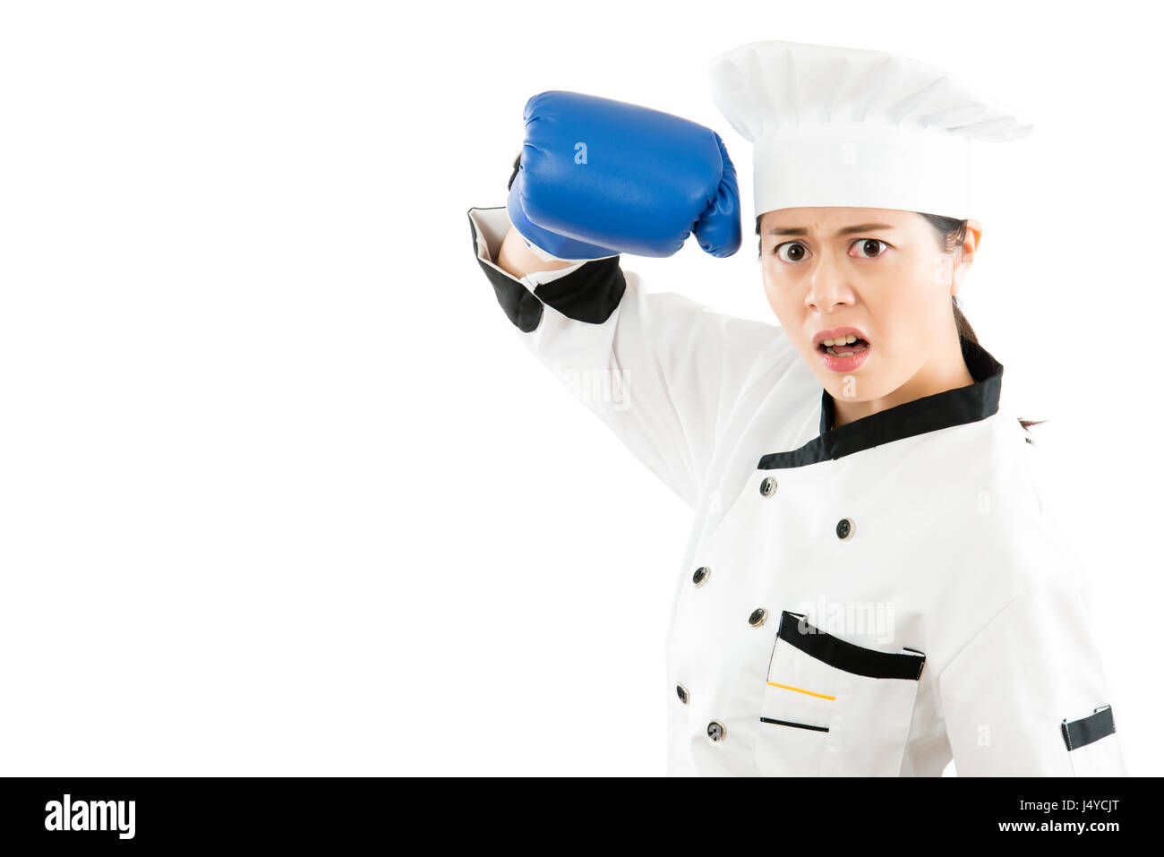 determined female cook pretending to fight attack punch pose with ...