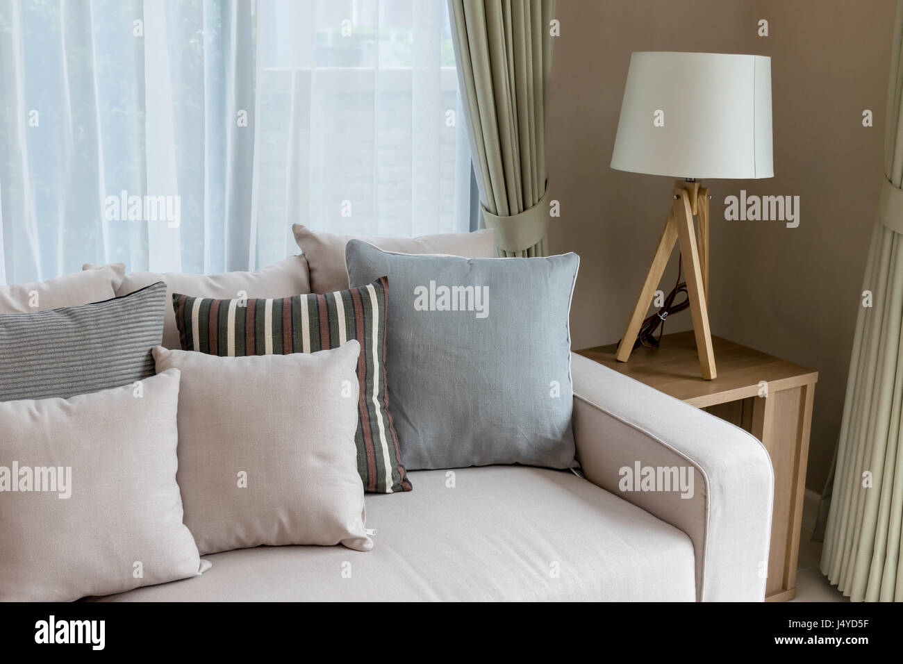 modern living room design with sofa and wooden lamp Stock Photo - Alamy