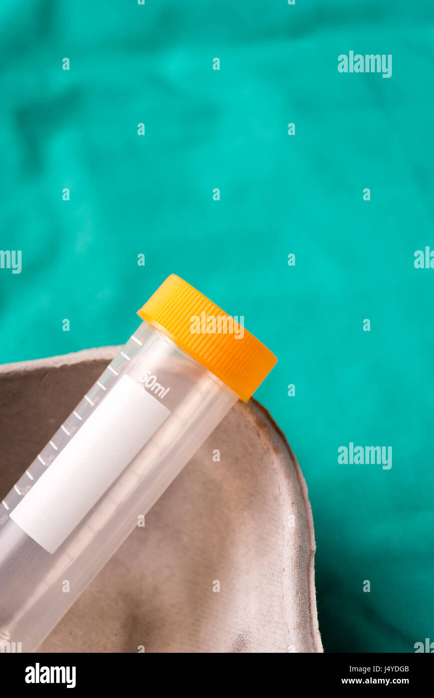 Medical test tube lying in a one use capsule on the hospital's green ...