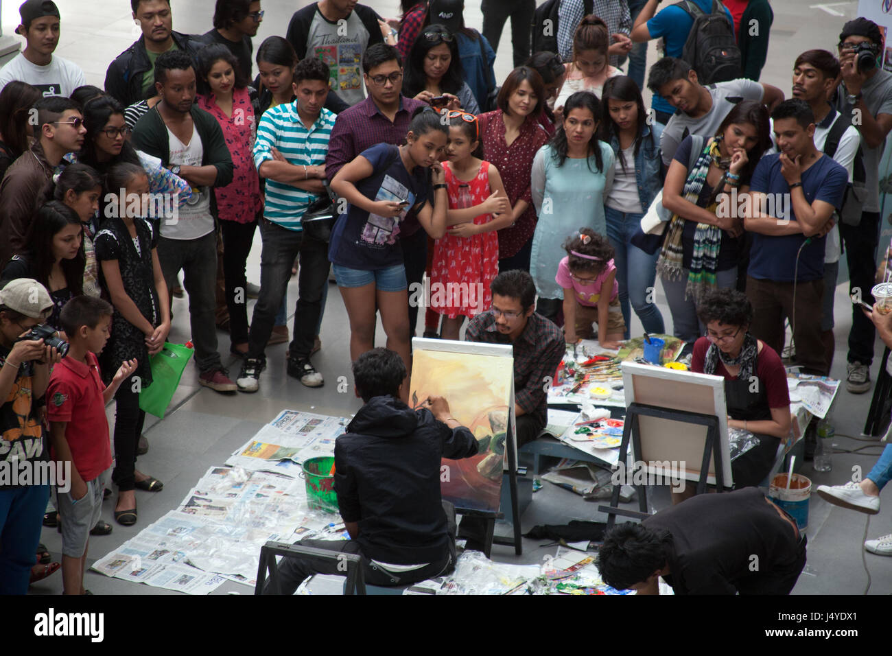 People watching the Art 25 live painting competition in Labim Mall ...