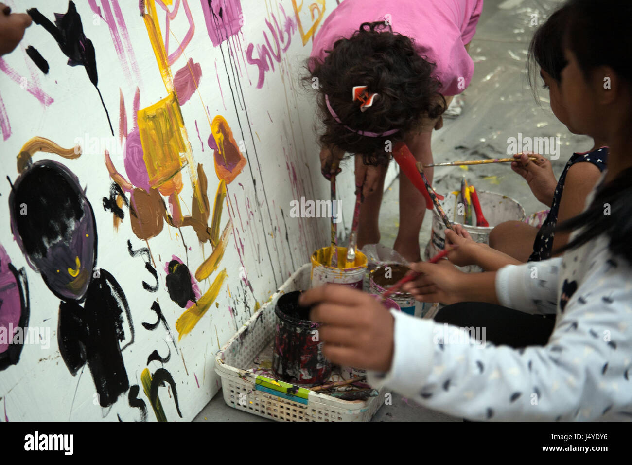 Children painting as part of the Art 25 live painting competition in ...