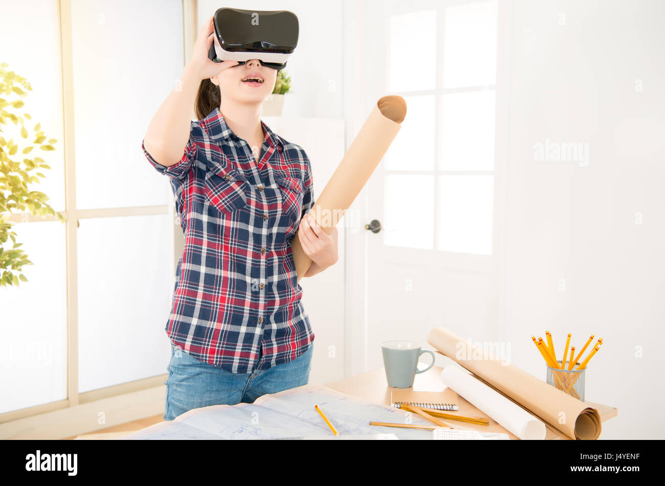 architect woman holding paper draft experience VR virtual reality ...