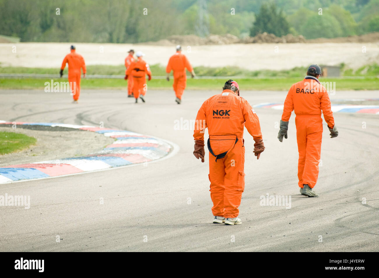 Track safety marshalls inspect the circuit for debris between races at ...