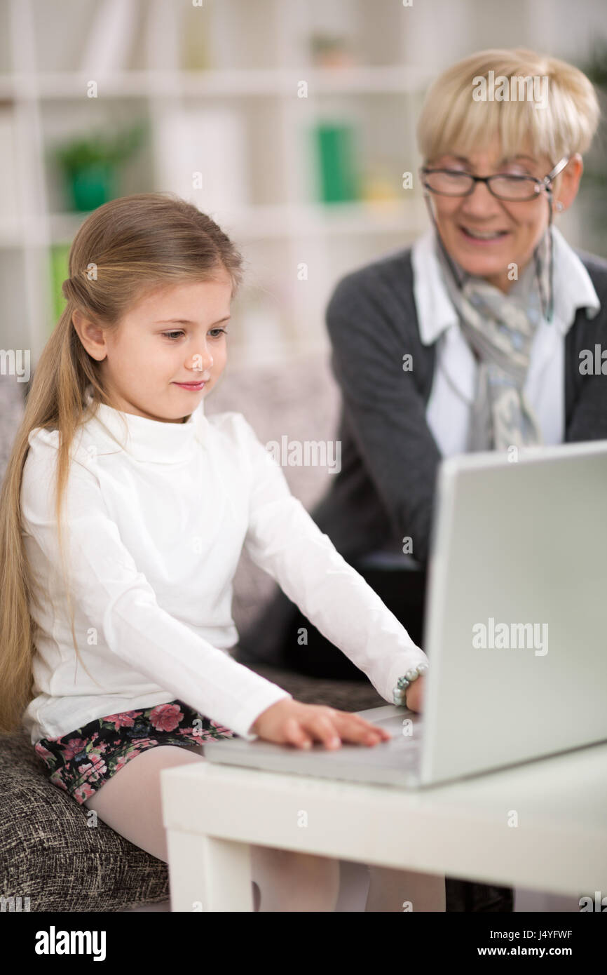 Grandmother with young girl use computer laptop happy together Stock ...