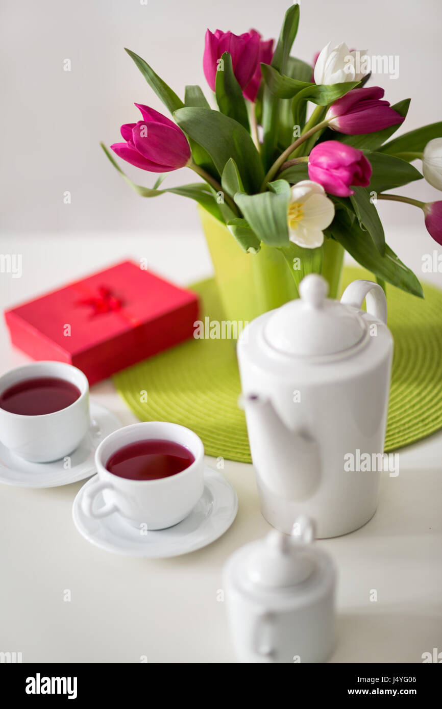 Tea set with flowers on table Stock Photo - Alamy