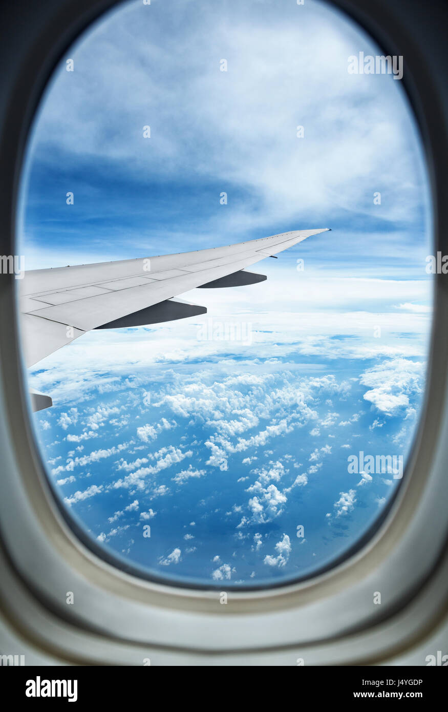 airplane window with wing and cloudy sky behind Stock Photo - Alamy