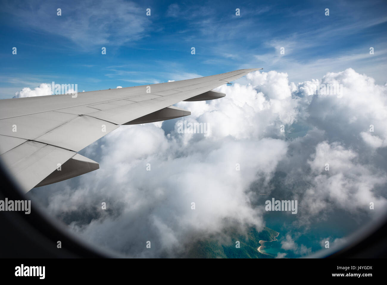 View from a jet plane window high on the blue sky with clouds Stock ...