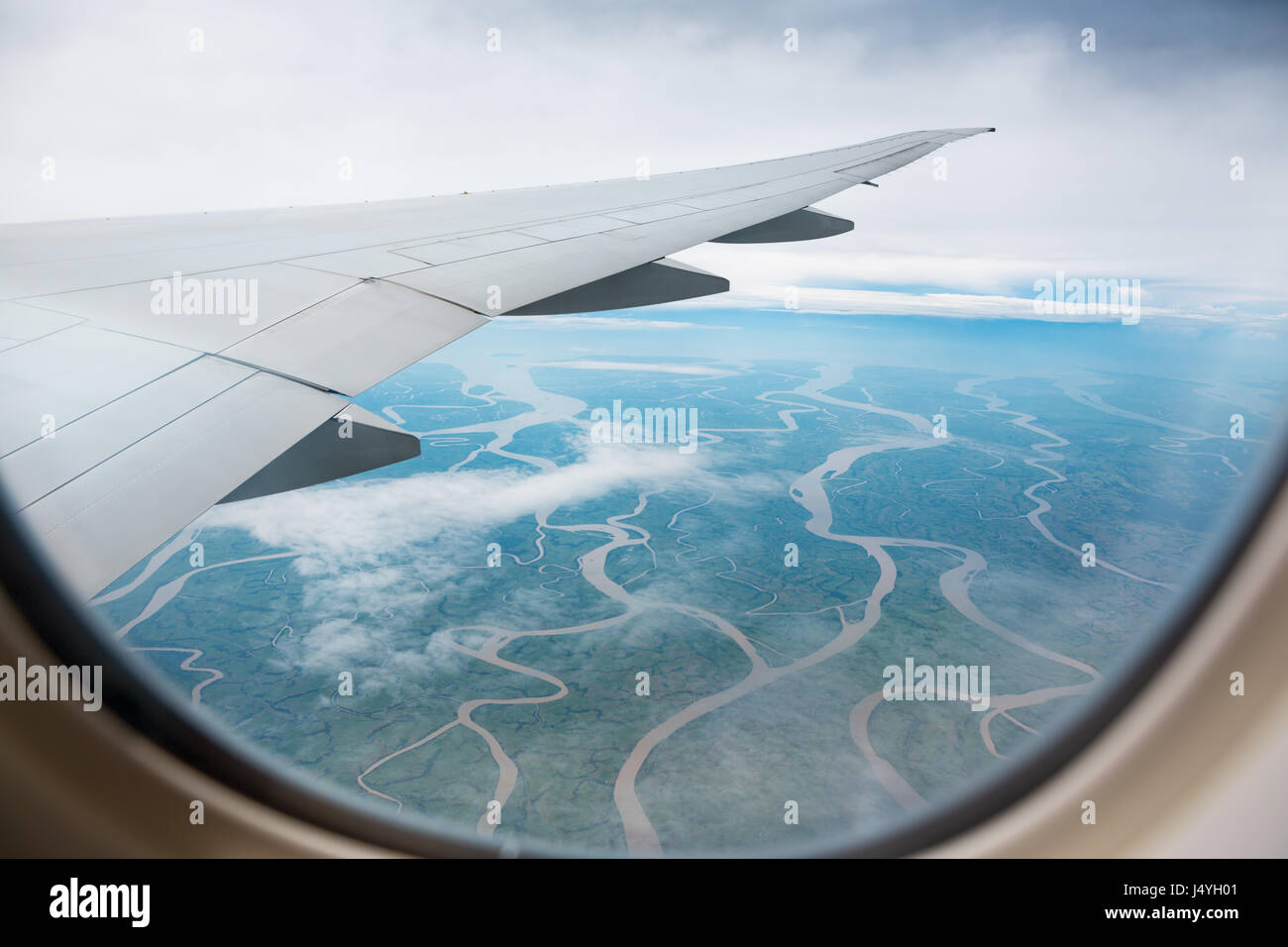 the view from the airplane window to the ground dotted with rivers ...