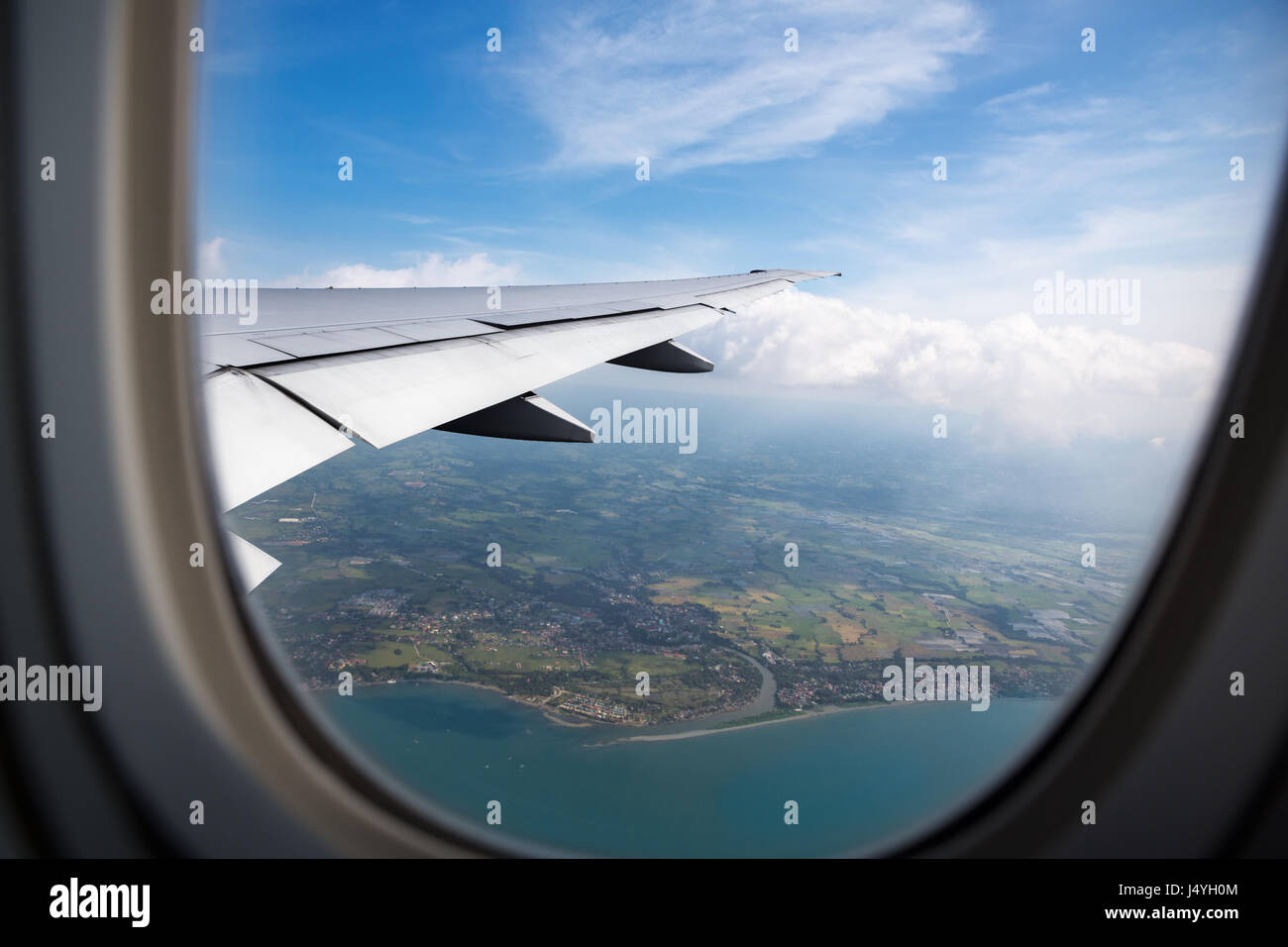 Earth, ocean and plane wing view from plane window Stock Photo - Alamy