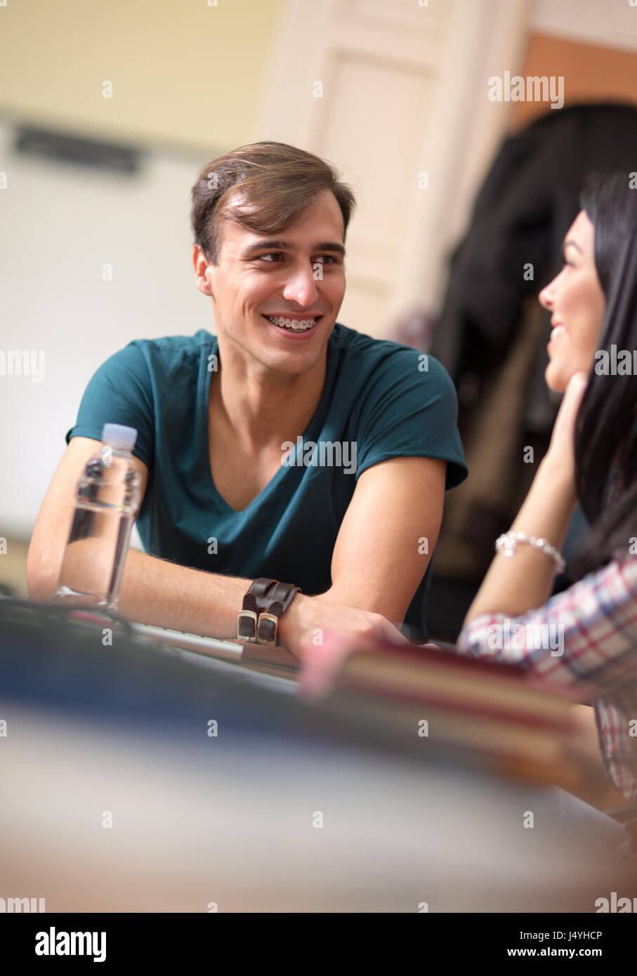 Conversation of two classmates on break after class Stock Photo - Alamy