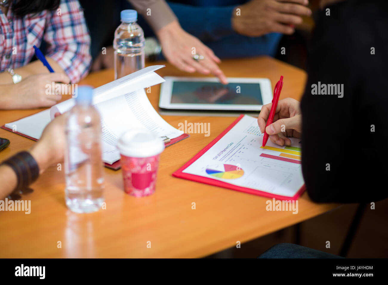 Close up view of working hands on table with chart Stock Photo - Alamy